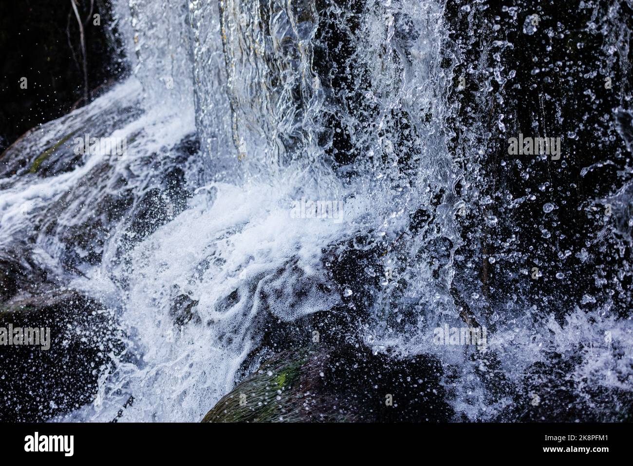 The flow of clean water in the waterfall through stones, close-up ...