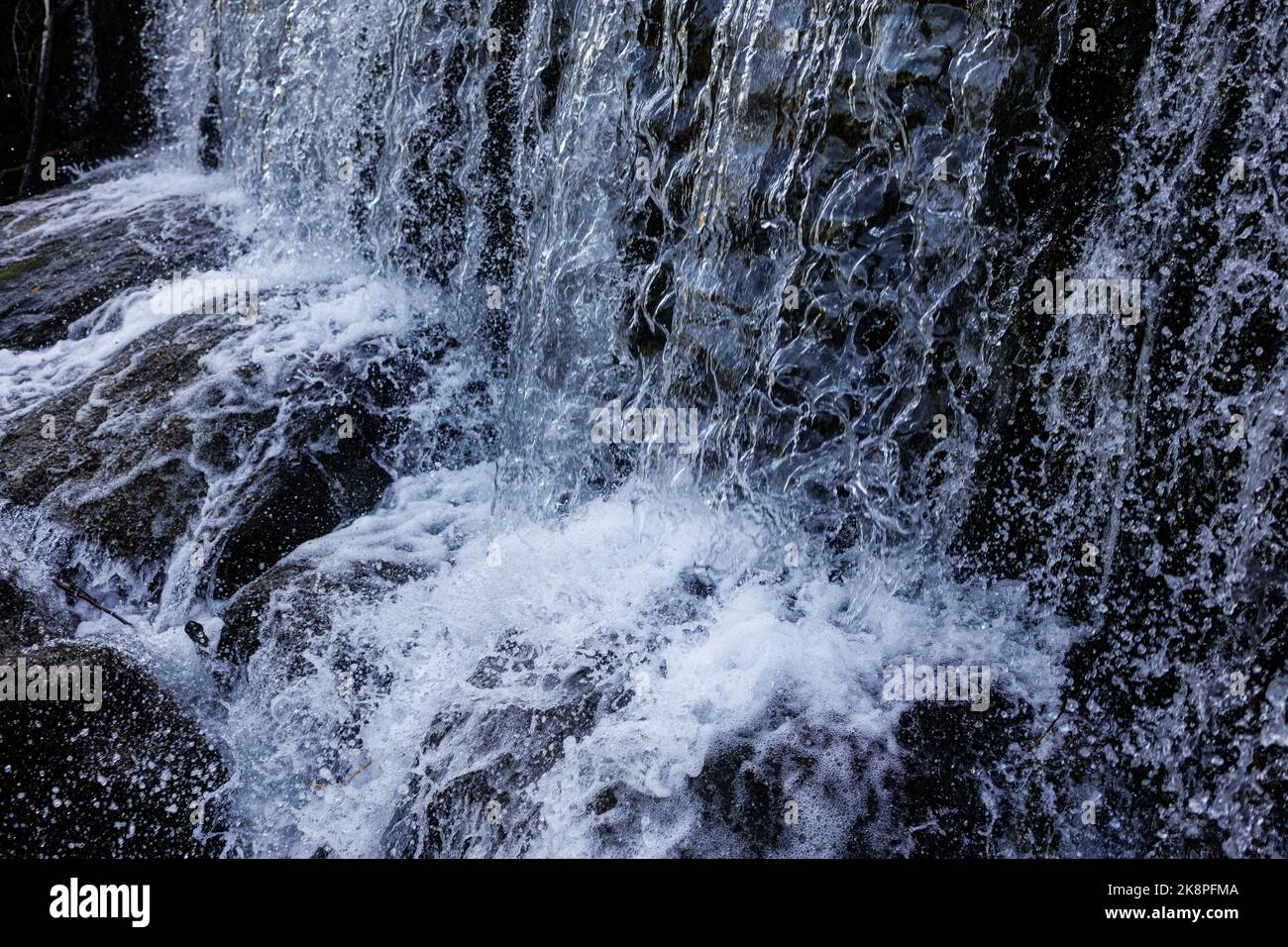 The flow of clean water in the waterfall through stones, close-up ...