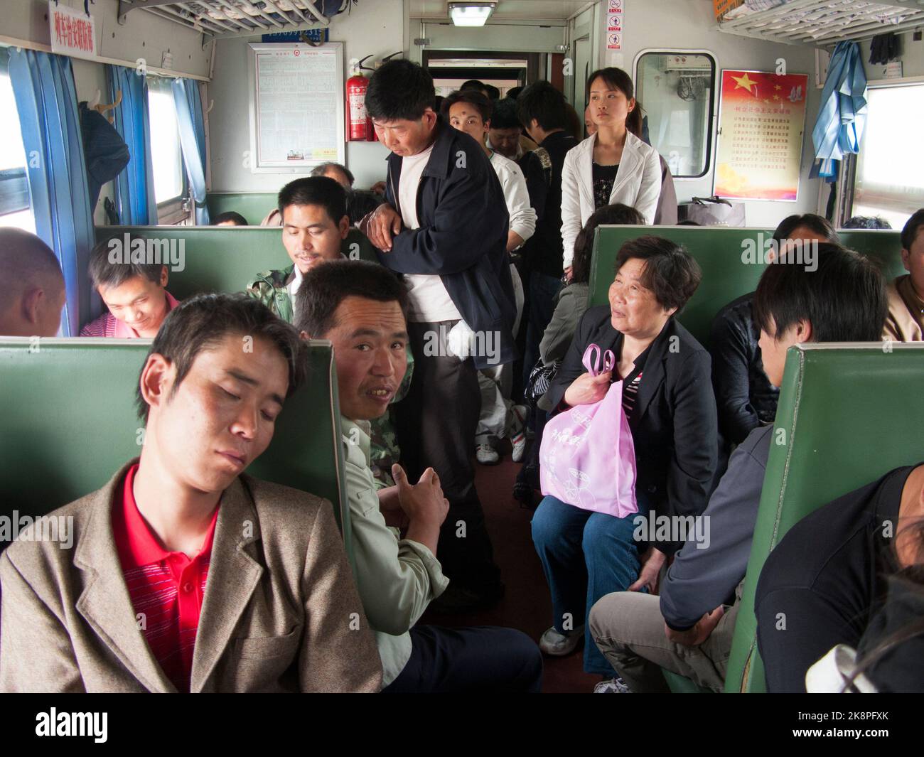 Railway train passengers in a passenger train carriage, on a journey to ...