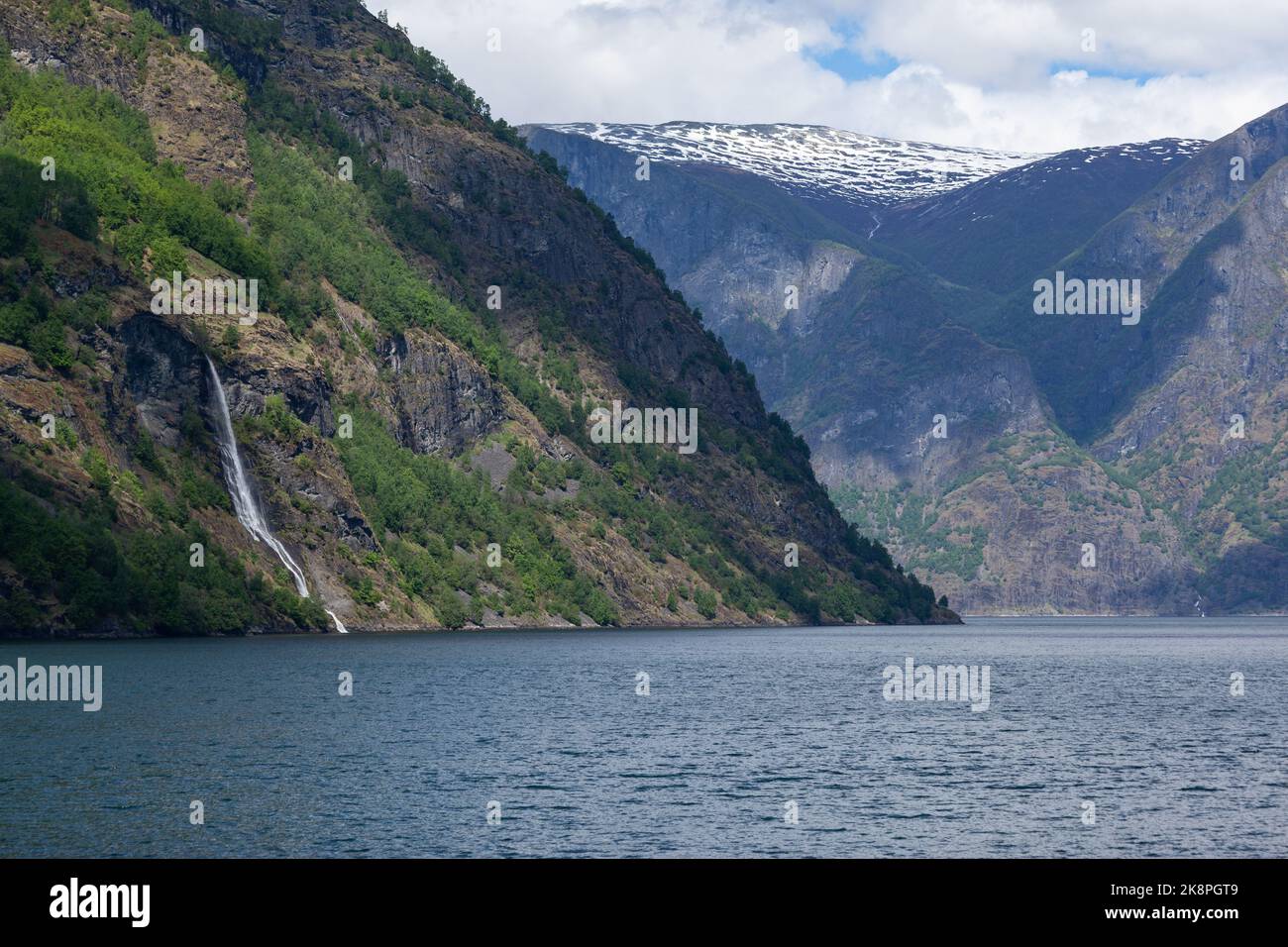A Narrow Fjord surrounded by mountains covered with trees in Vestland ...