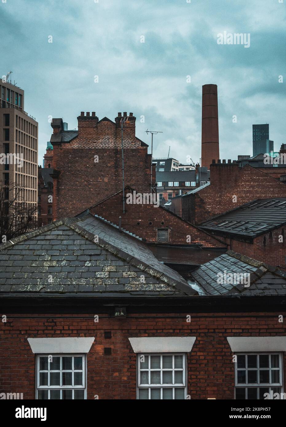 A vertical shot of city buildings in Manchester, United Kingdom Stock ...