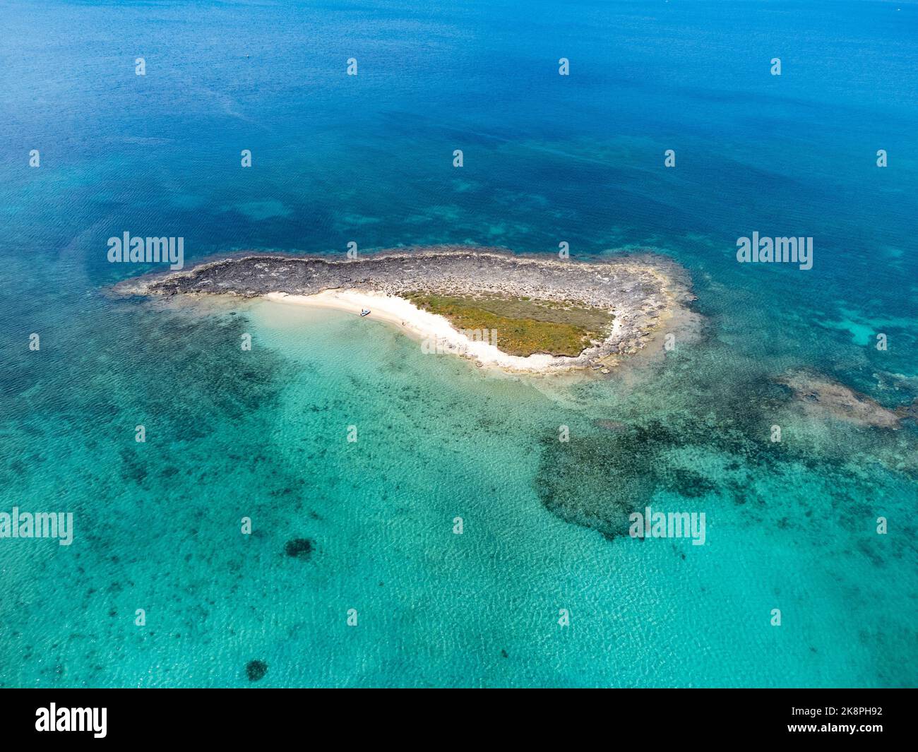 An aerial view of small tropical islet in the middle of shallow ...