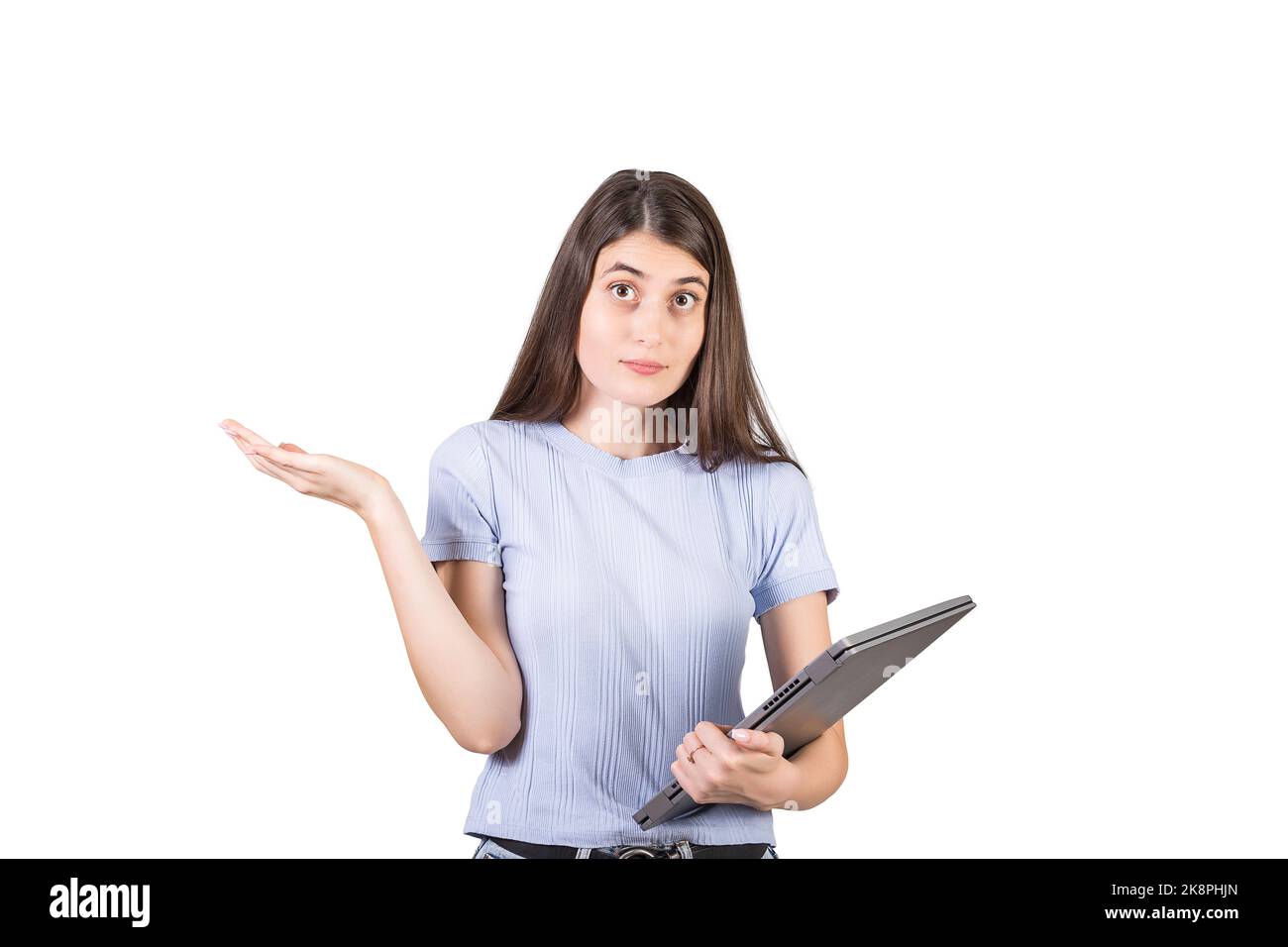 Perplexed young woman shrugging shoulders as holds a defect laptop in ...