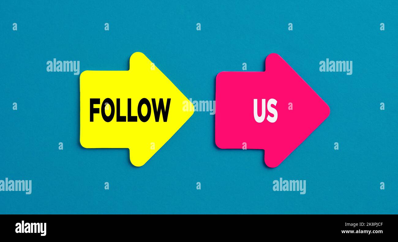 Follow us concept. The word follow us on arrow shaped stickers on blue ...