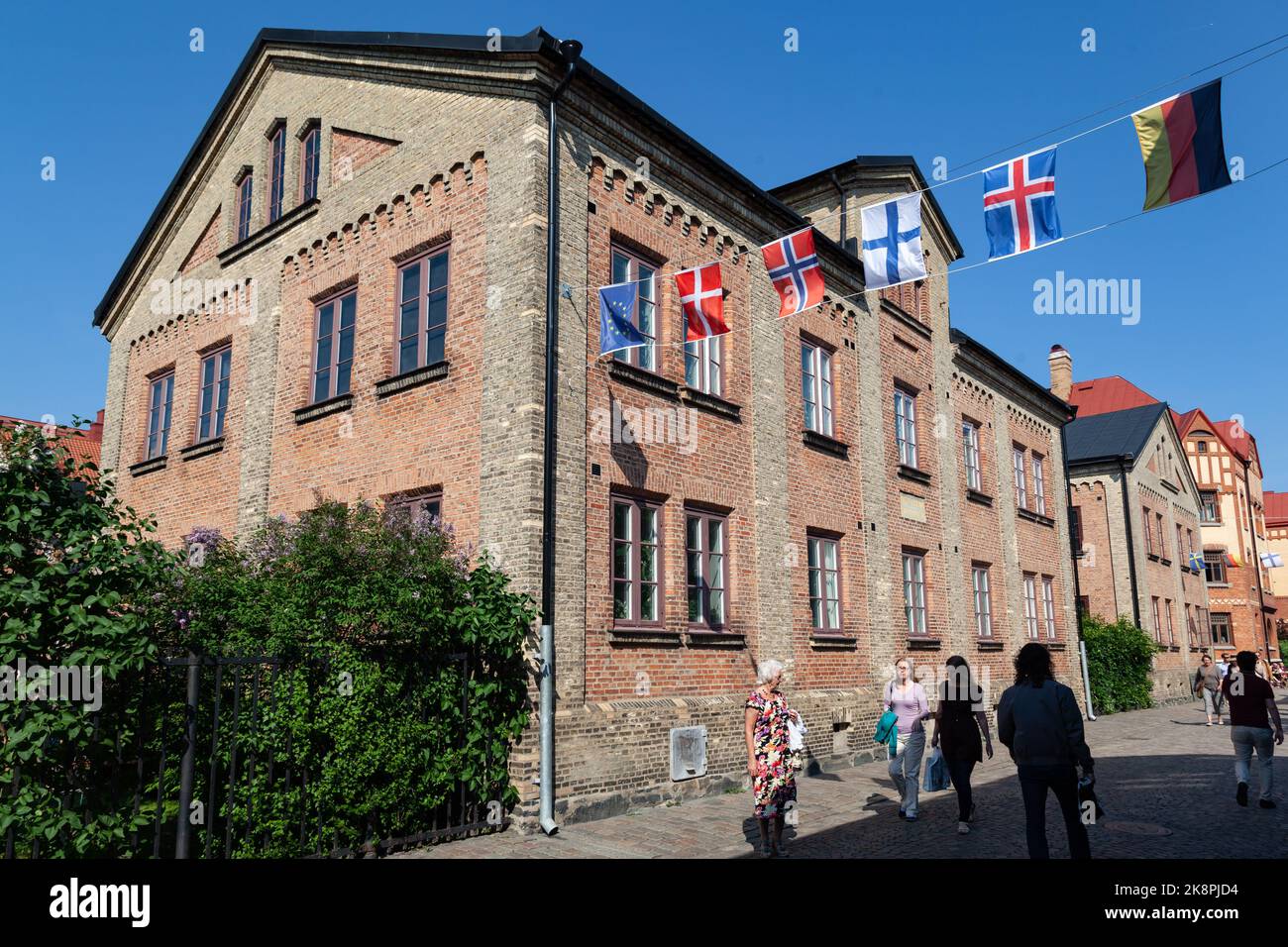 A beautiful historic building facade with hanging Scandinavian flags in ...