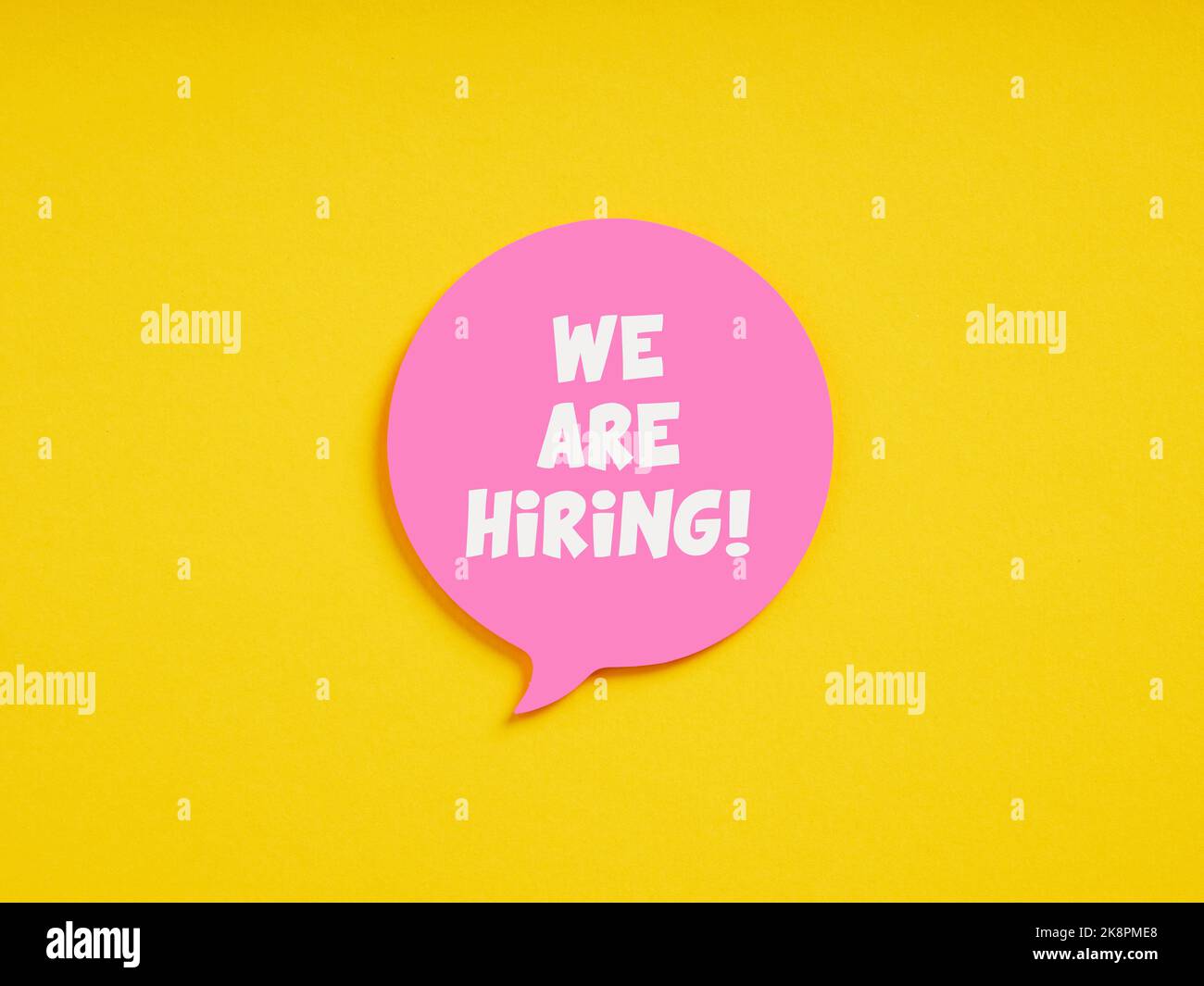 The message we are hiring on pink speech bubble on yellow background ...