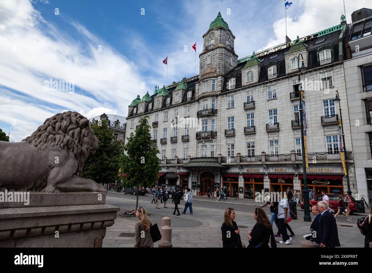 The facade of the Grand Hotel Oslo historical building with a statue of ...