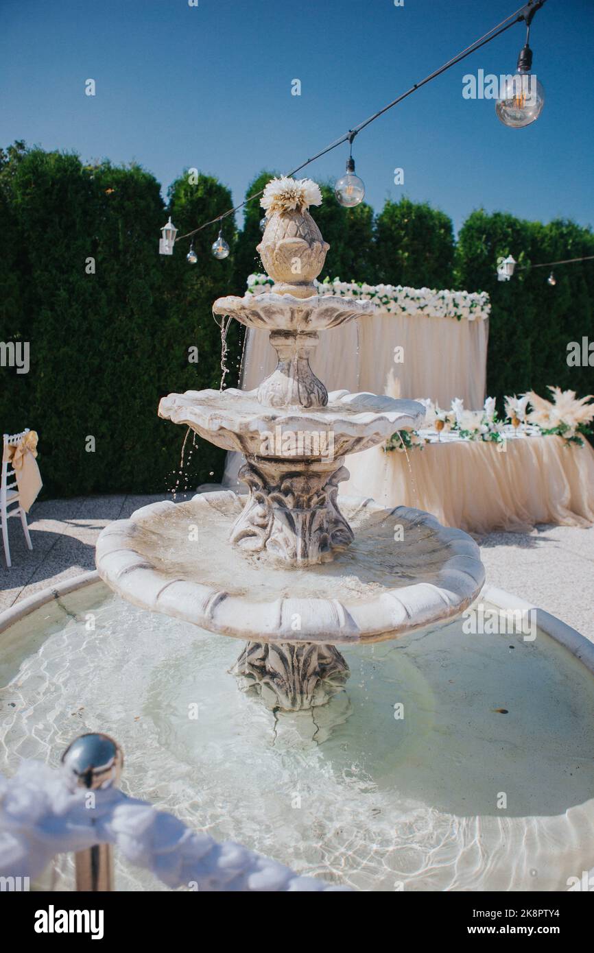 A small water fountain with decorations in the background at outdoor ...