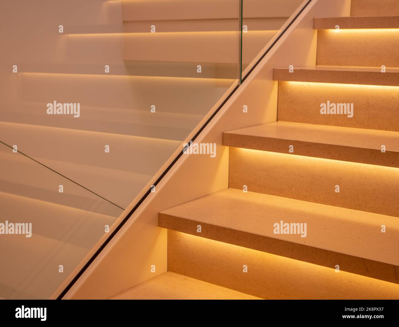 The part of the stairs in light marble with bright LEDs below the steps ...