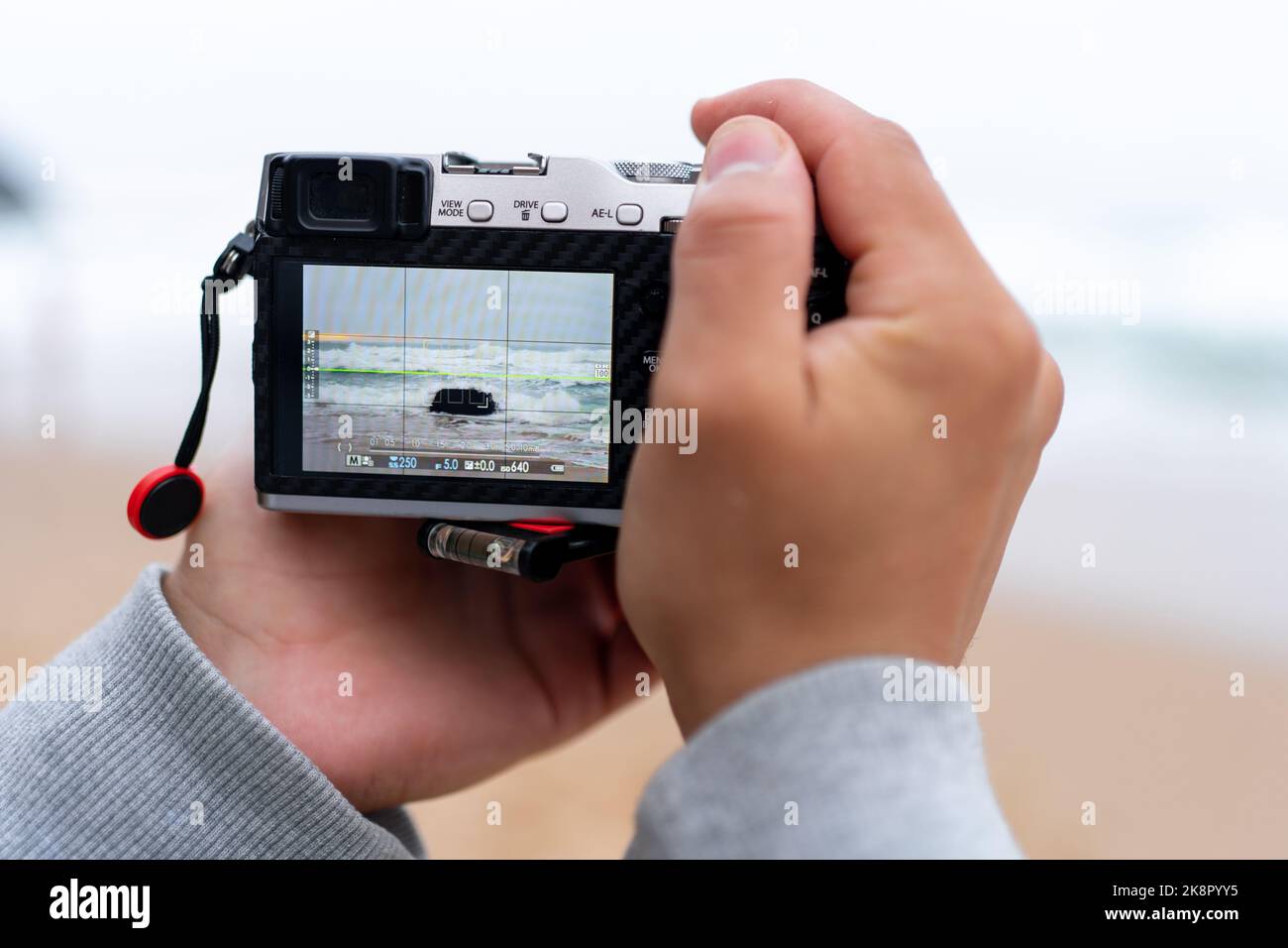 Traveller make photo using mirrorless camera in hand, travel blogger ...