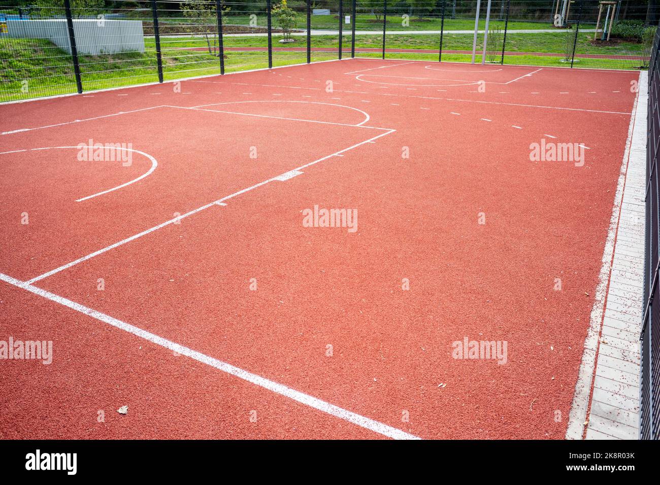 The view of an outdoor basketball court in a competition center - red ...