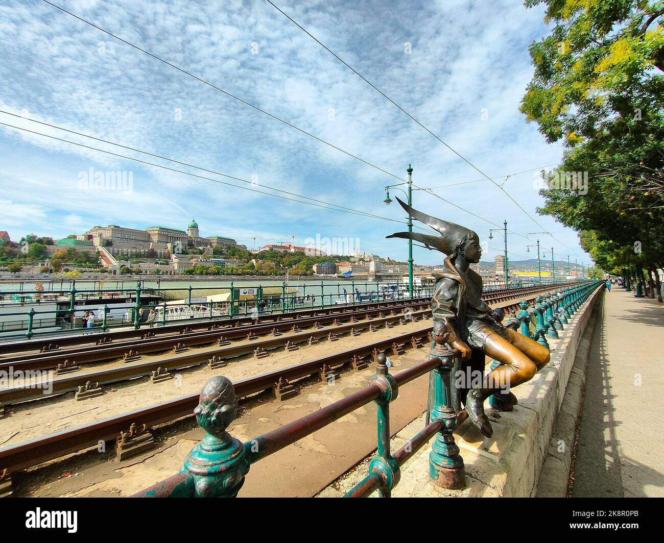 A beautiful shot of Little Queen sculpture sitting on a railroad along ...