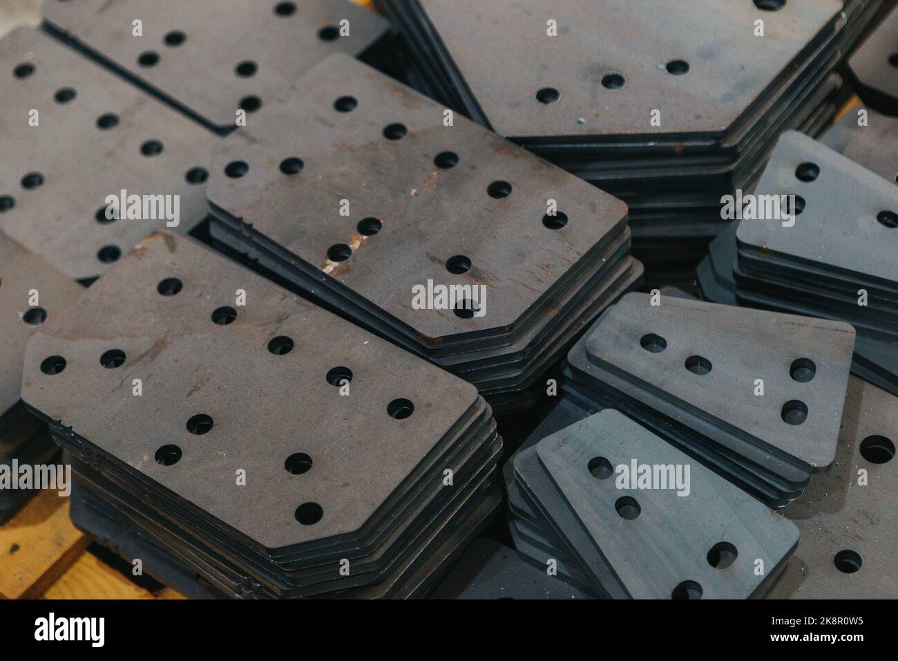 A bunch of different kinds of connecting plates stacked in neat piles ...