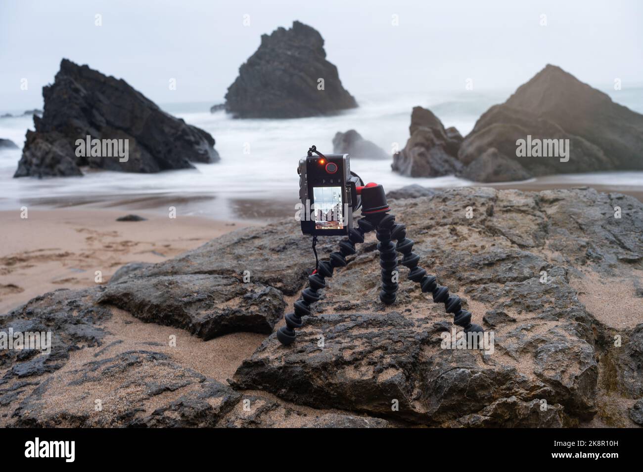 Digital mirrorless photo camera on flexible tripod to making photo of ...