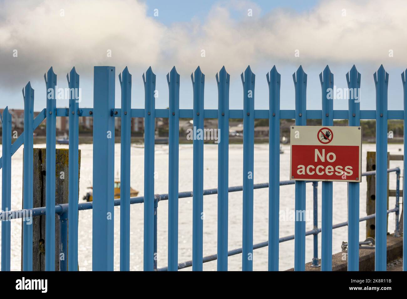 red no access sign on a blue metal fence Stock Photo - Alamy