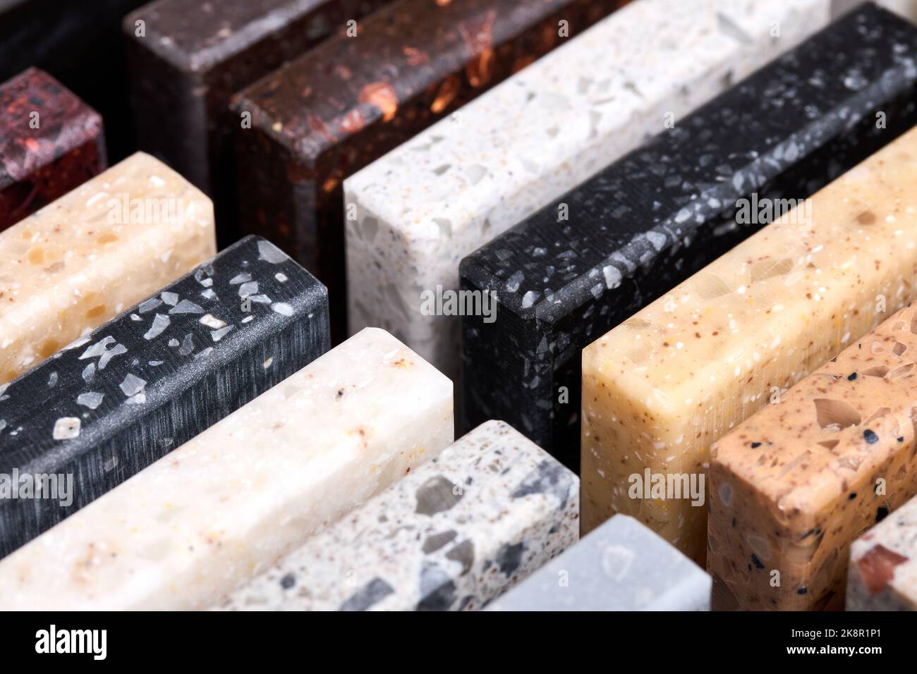 Porcelain stoneware square samples laid on kitchen countertop as ...