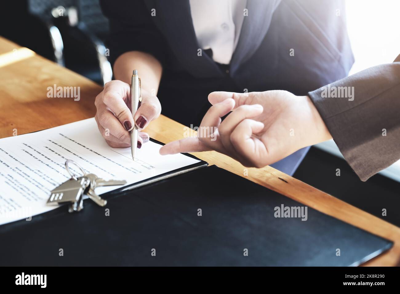 estate agent gives pen and documents agreement with customer to sign ...