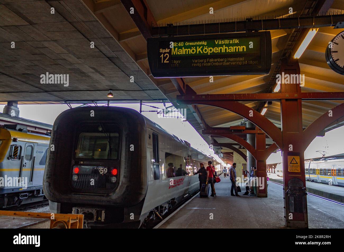The trains in Gothenburg train stations with people on the platform in ...