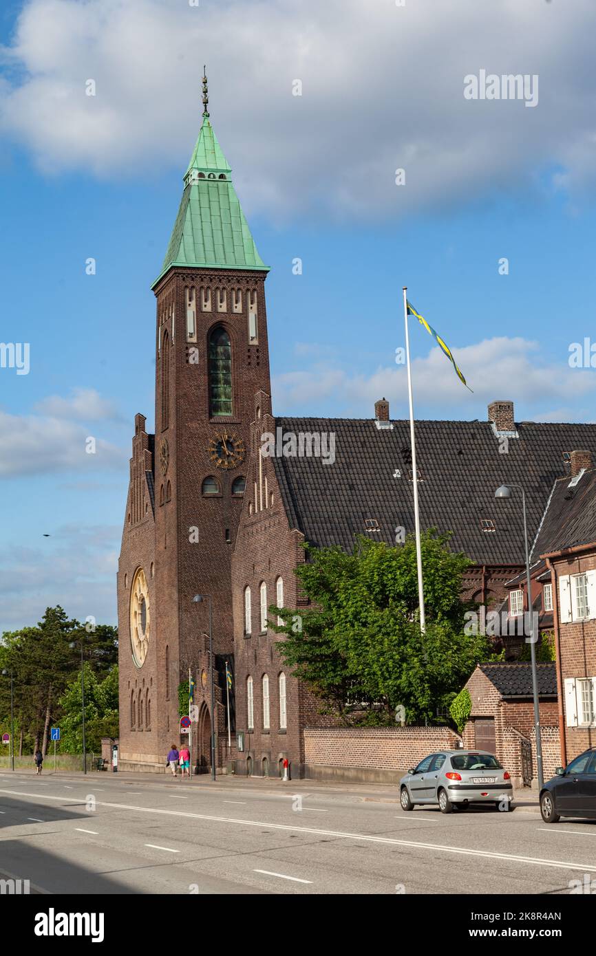 A vertical shot of the Gustaf single clock tower brick church in ...