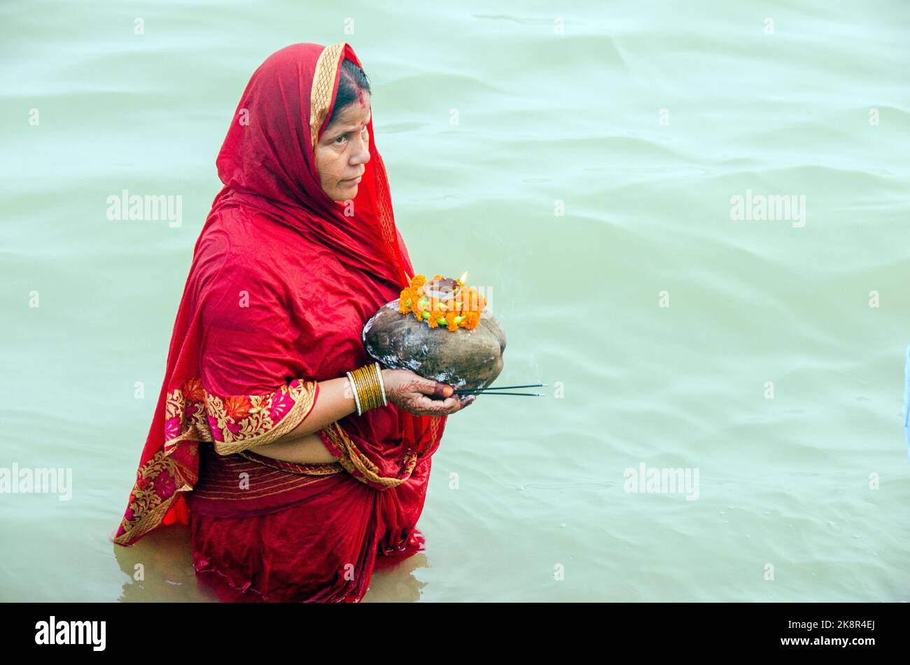 Unidentified Indian men and women pray and devote for Chhath Puja ...