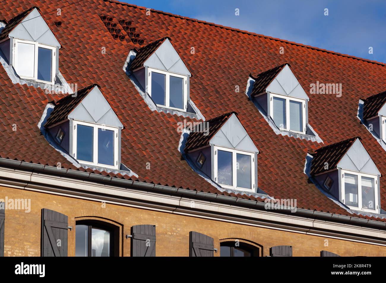 A low angle shot of a historic house roof with windows in Copenhagen ...