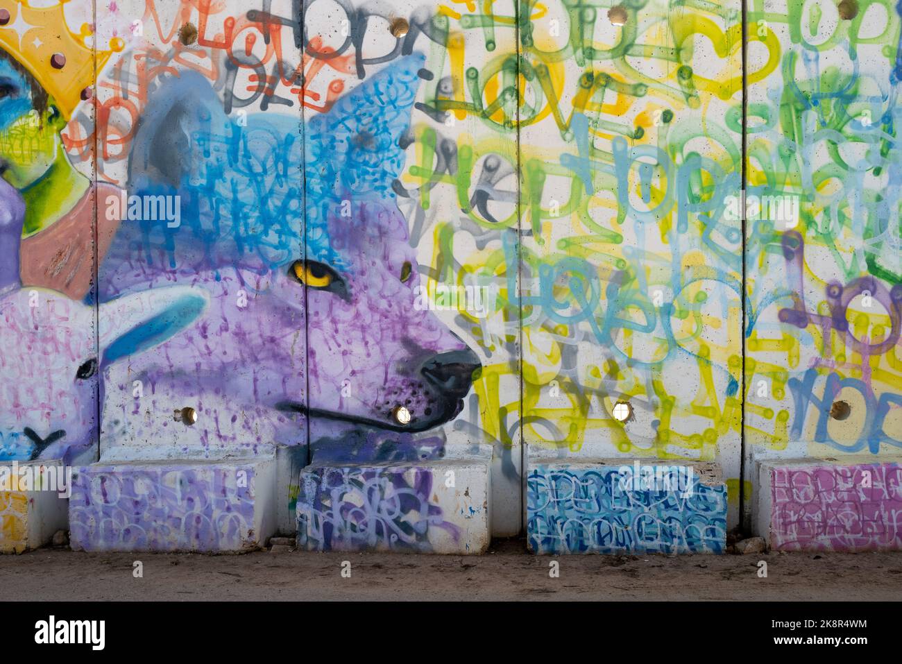 A wall with a white wolf and lamb artwork - Graffiti art wall at the ...