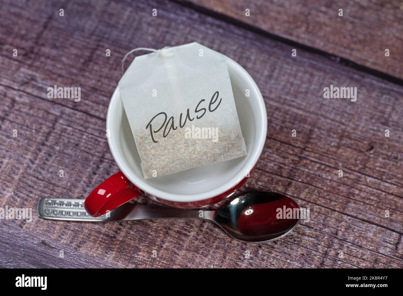 Cup and tea bag labeled 'Pause' Stock Photo - Alamy