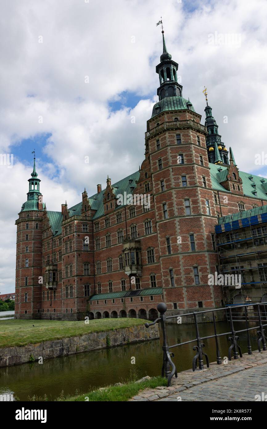 A vertical shot of the historic Frederiksborg castle on the water in ...