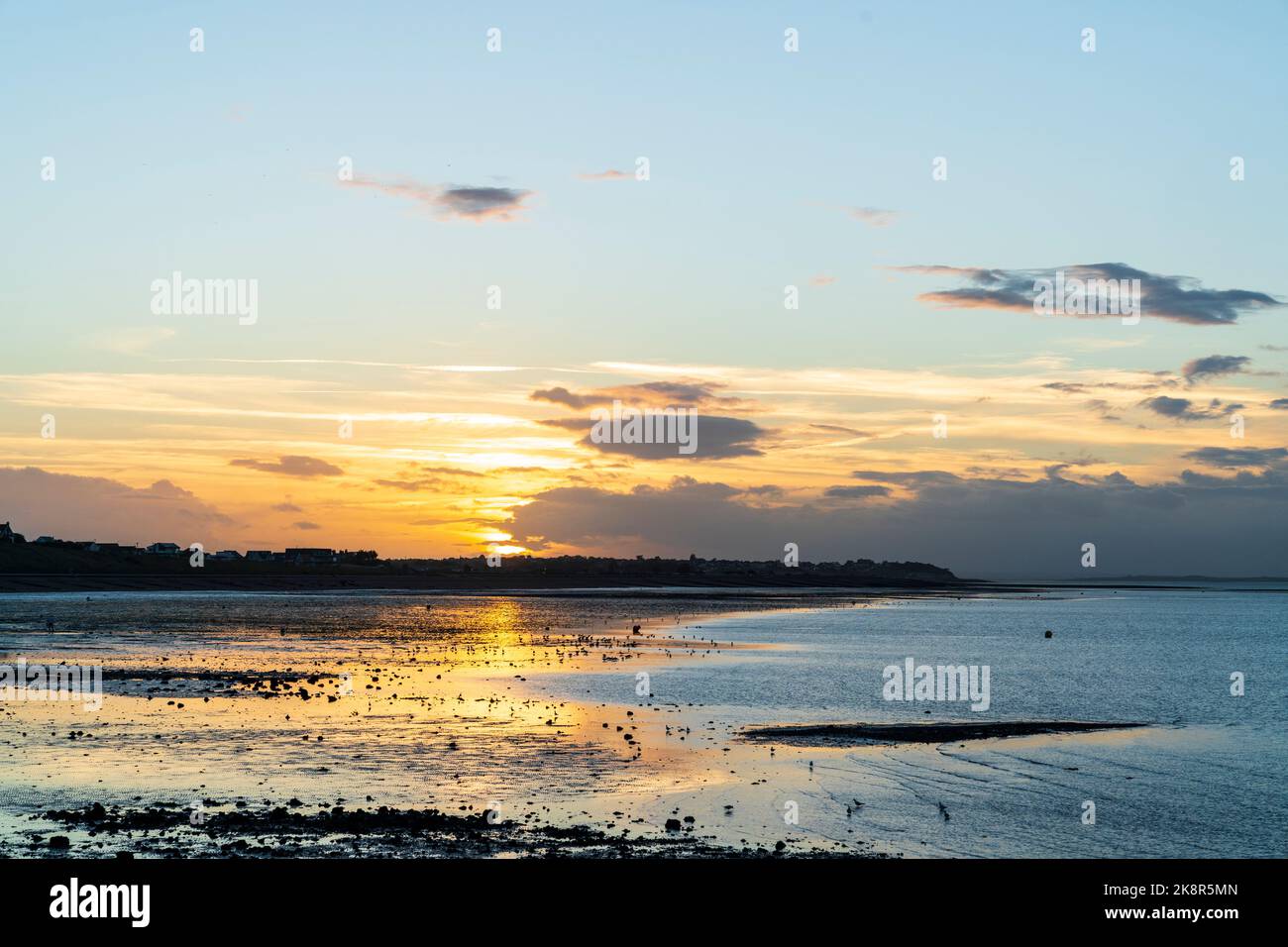 Sunset with a cloud layer on the horizon, over the Kent coastal town of ...
