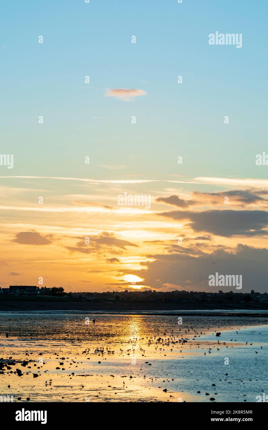 Sunset with a cloud layer on the horizon, over the Kent coastal town of ...
