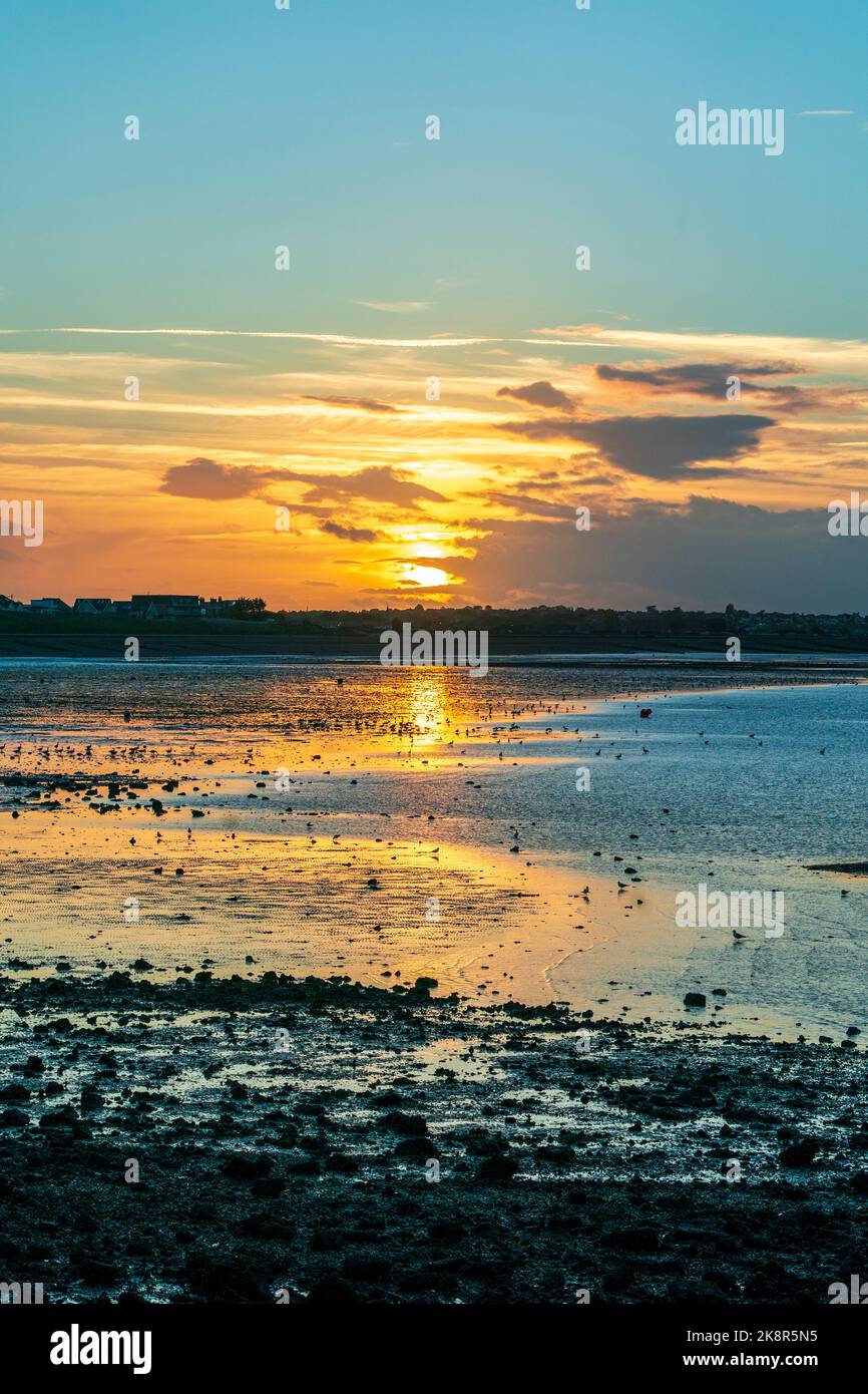 Sunset with a cloud layer on the horizon, over the Kent coastal town of ...