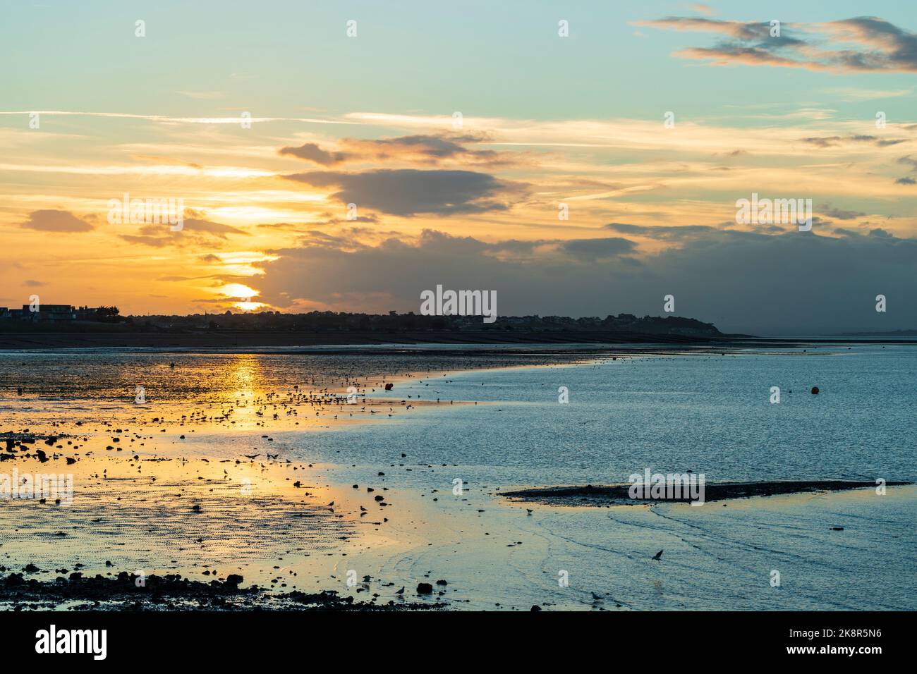 Sunset with a cloud layer on the horizon, over the Kent coastal town of ...