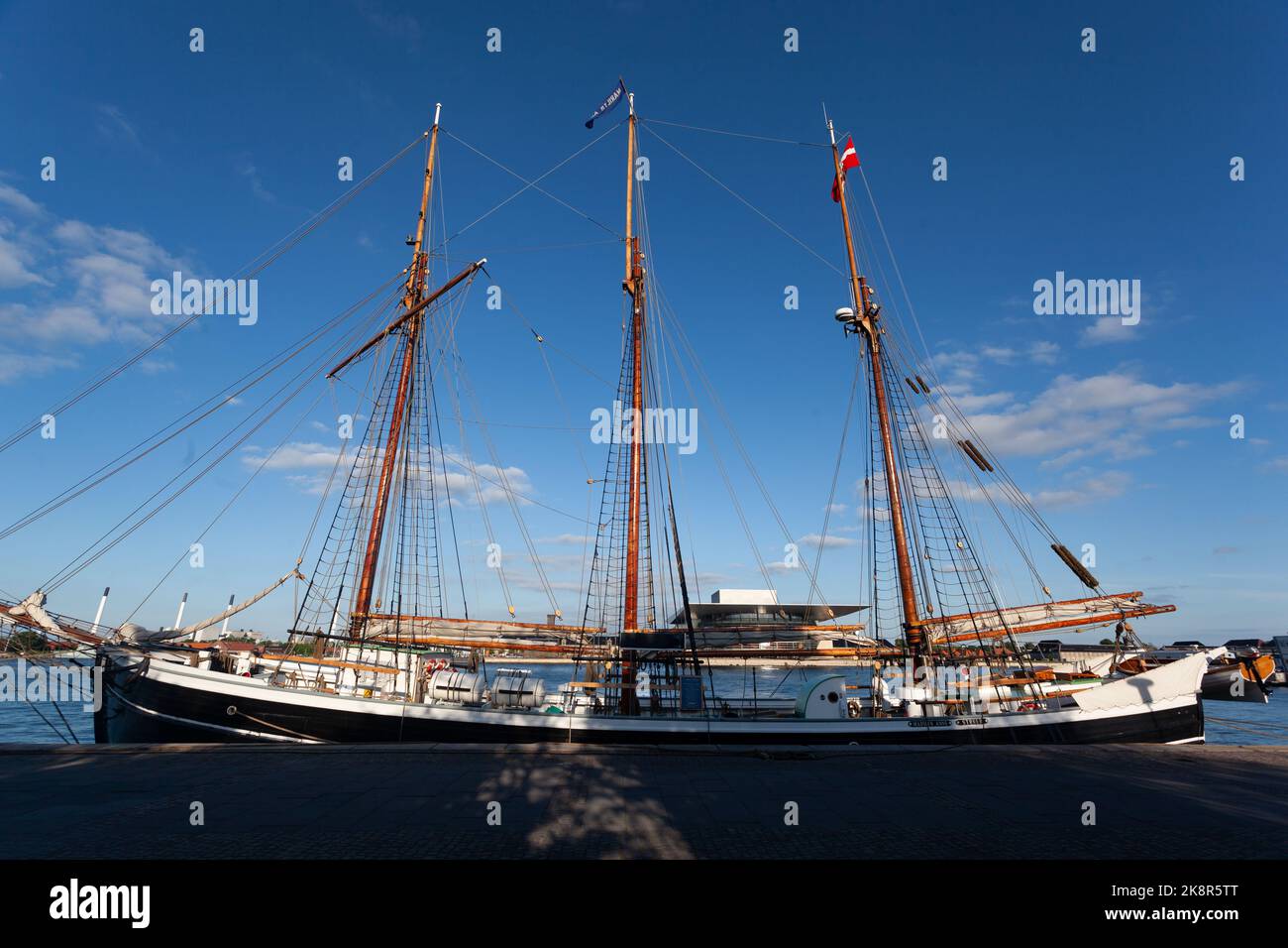 A low angle shot of a vintage old sailing boat on the water in ...
