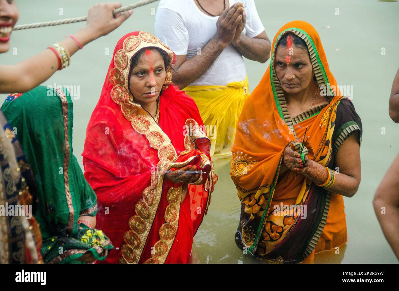 Unidentified Indian men and women pray and devote for Chhath Puja ...