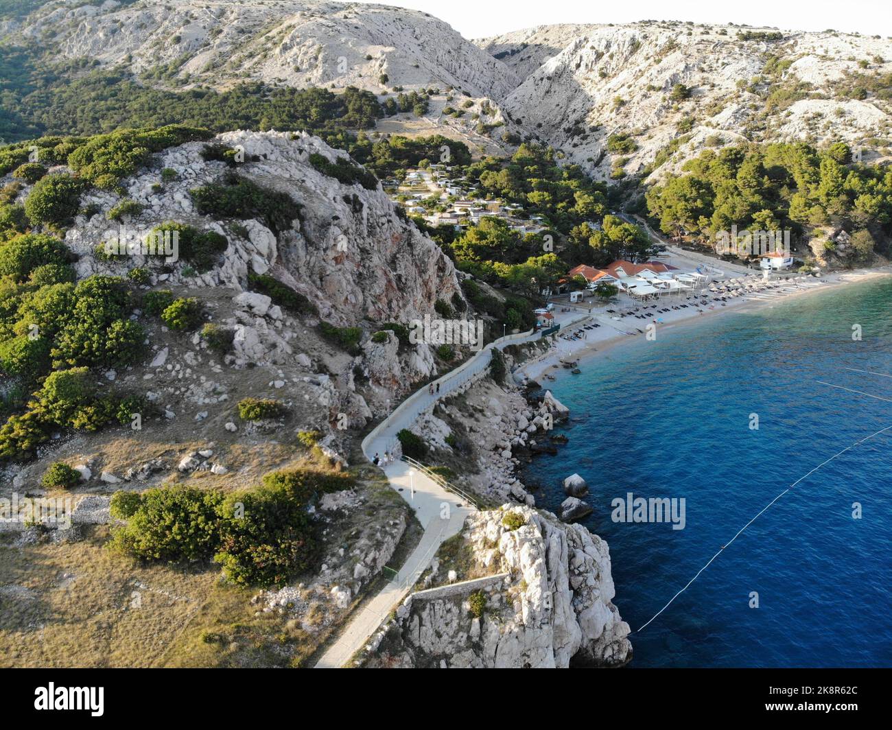 A scenic view of a beach resort in a valley in Baska, Krk island ...