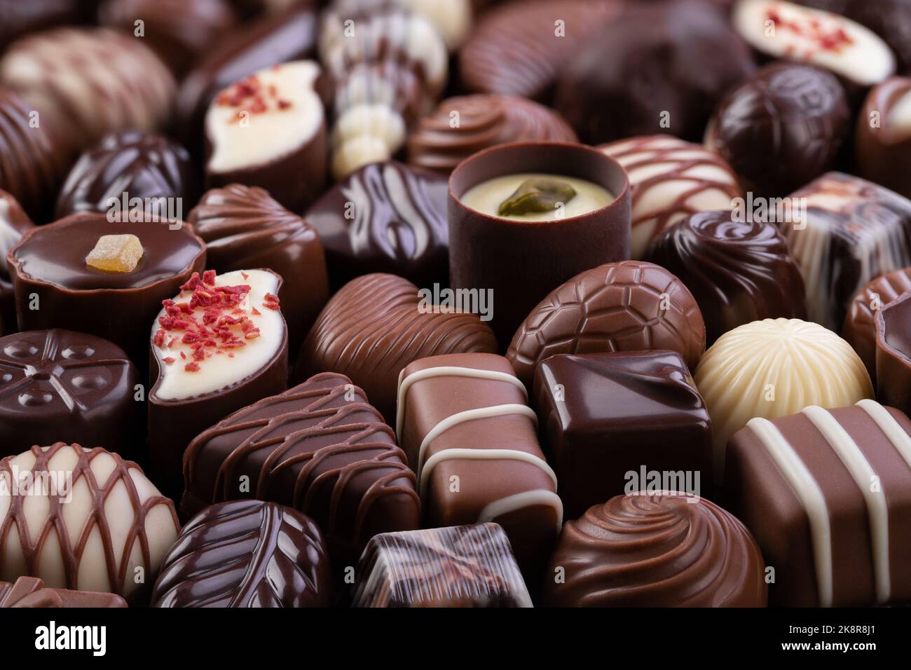 mix chocolate candy and other sweetmeat, dessert food background Stock ...