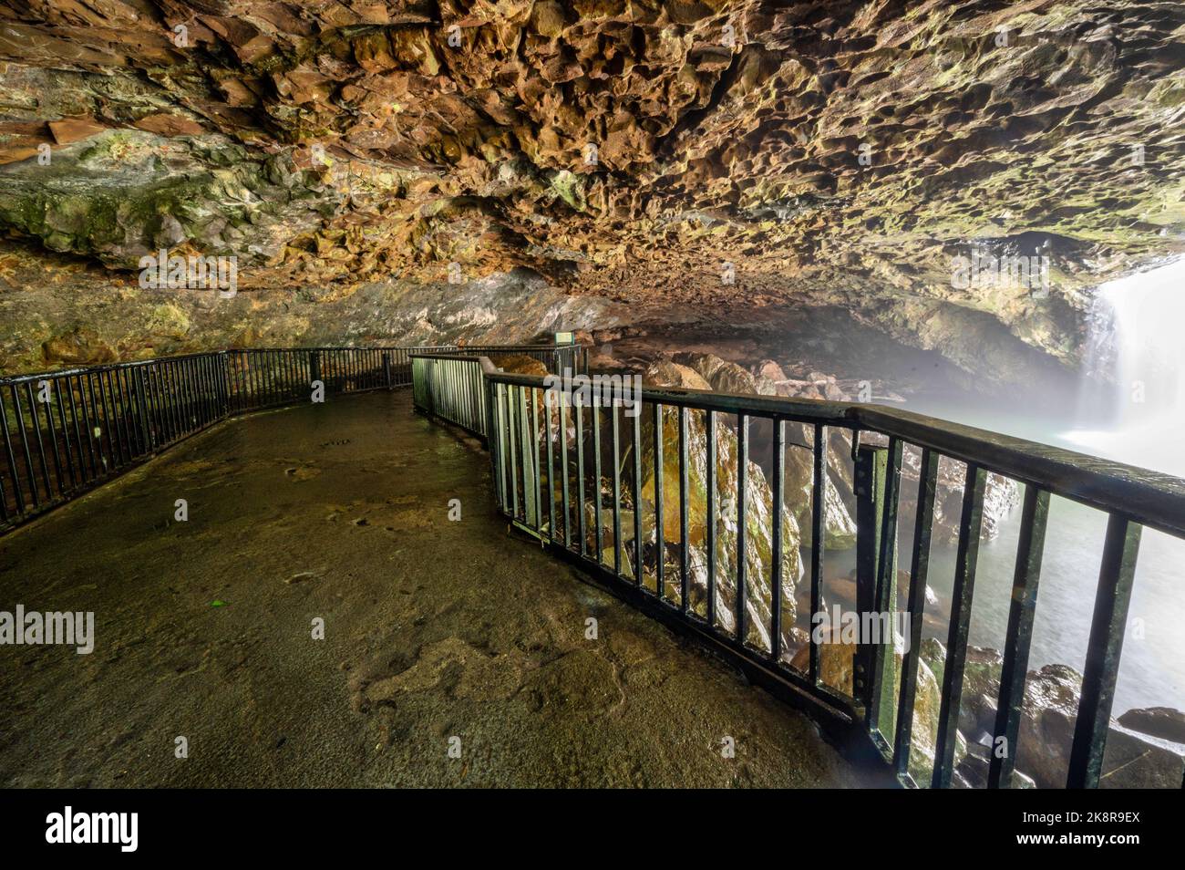 The Natural Bridge Falls Picnic Area with a cave and a waterfall in the ...