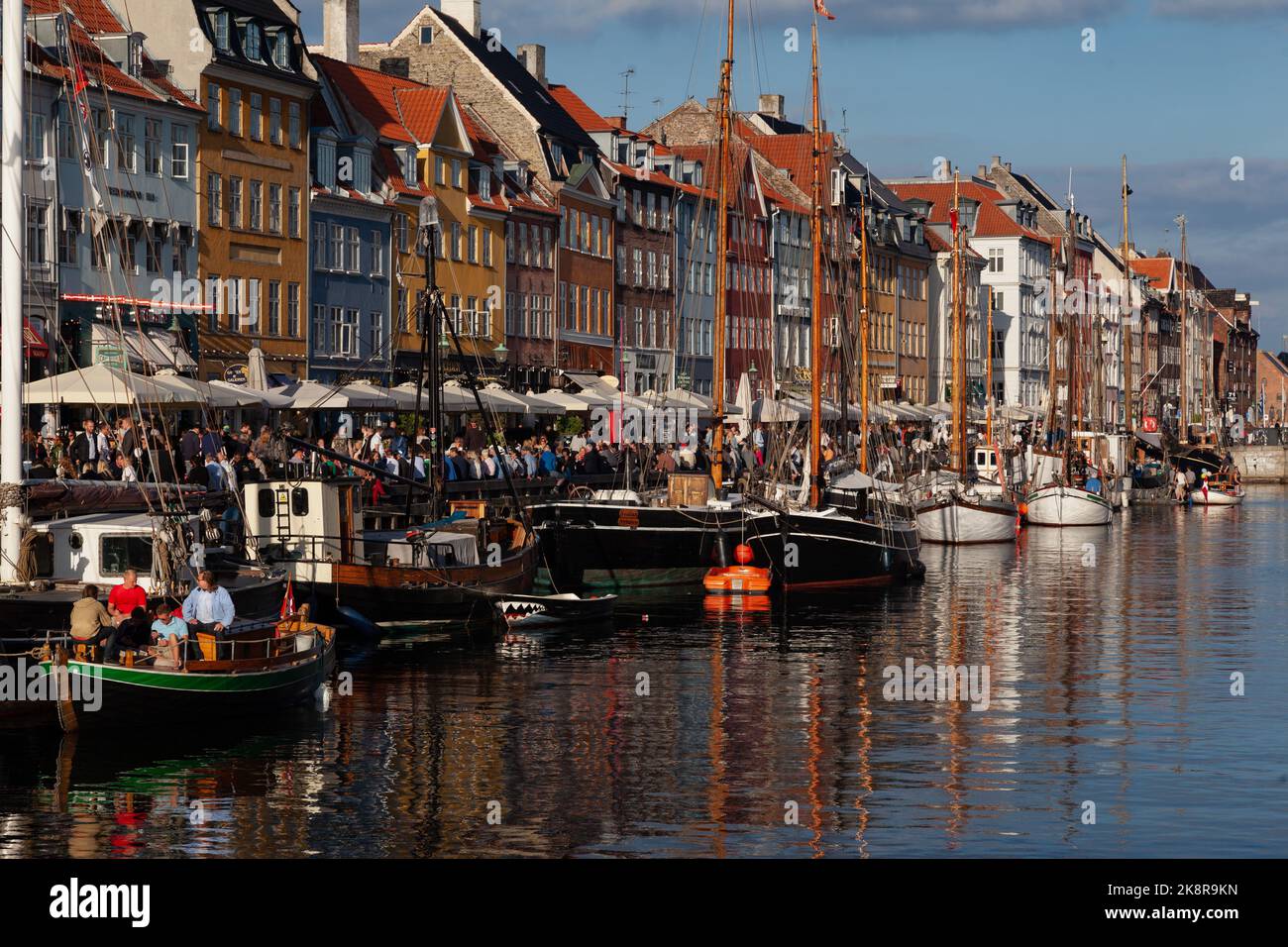 The beautiful Nyhavn neighbourhood with cafes on the shore of the water ...