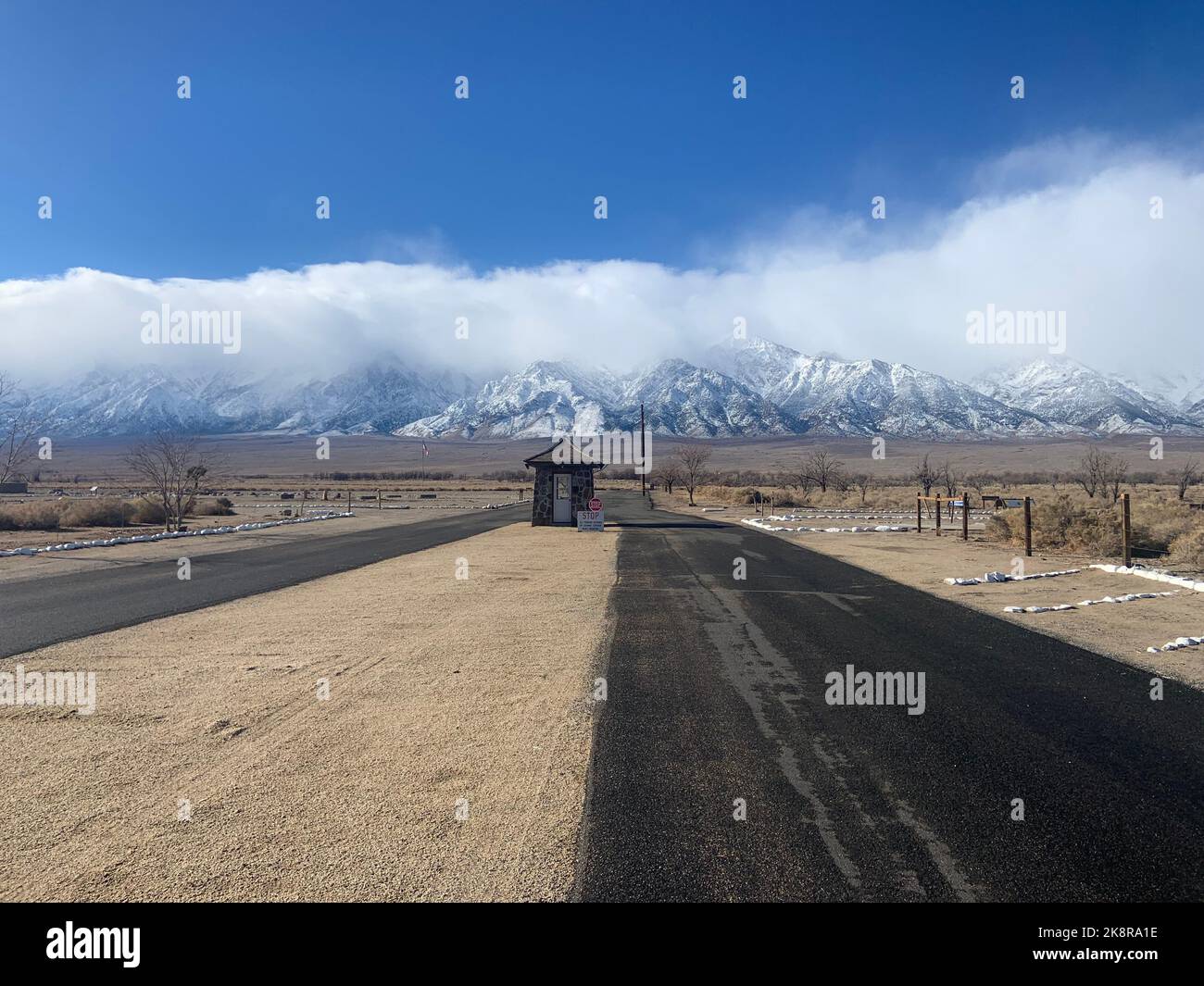 An asphalt road leading to Manzanar Historic WWII Camp in California ...