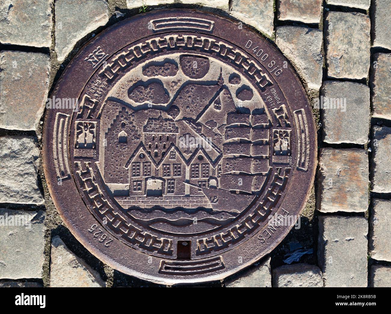 An iron cast sign on a street with the engraving of the historical ...