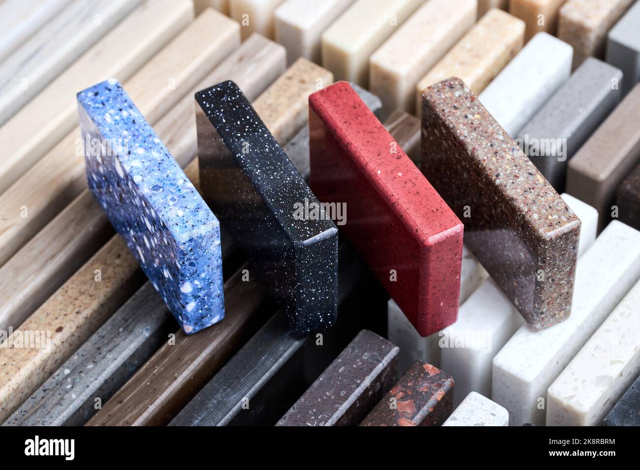 Porcelain four stoneware square samples laid on kitchen countertop ...