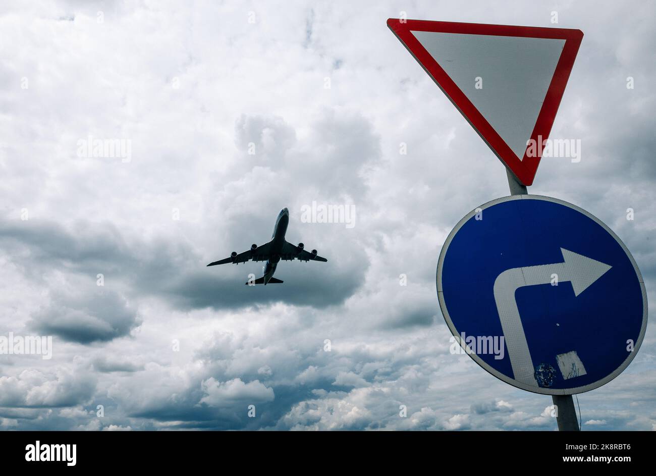 Road signs "Give way" and "Turn right" against the background of the ...