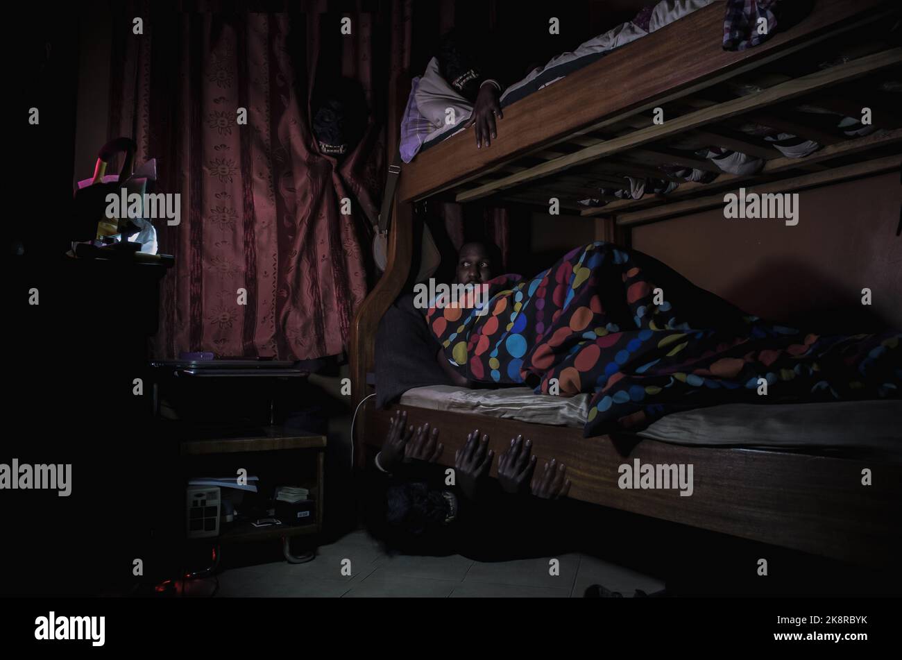 Black men lying on a bunk bed and under the bed Stock Photo - Alamy