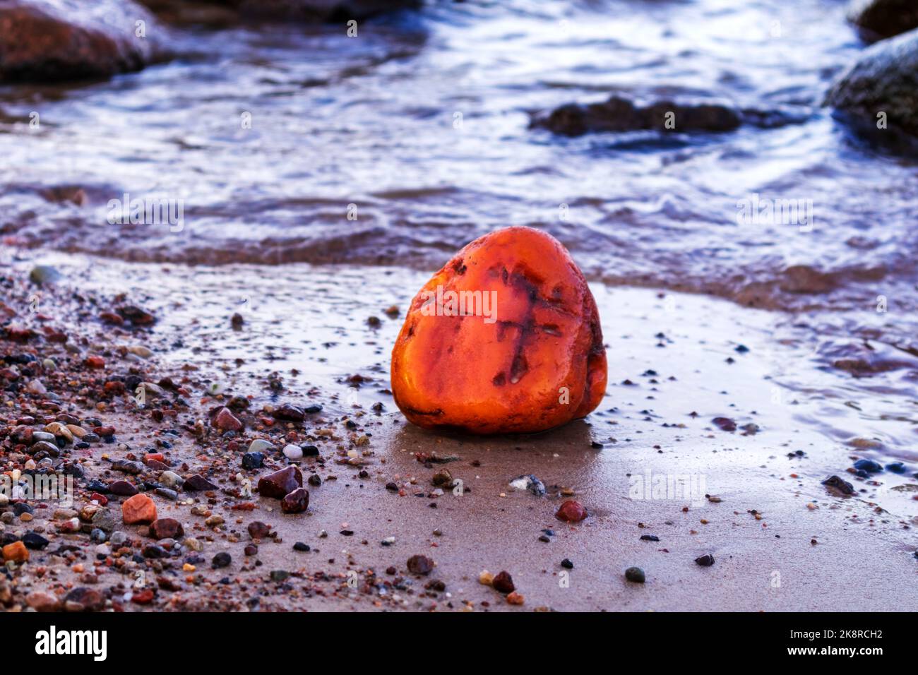 Huge bright yellow amber with sand, Baltic sea and rocks Stock Photo ...