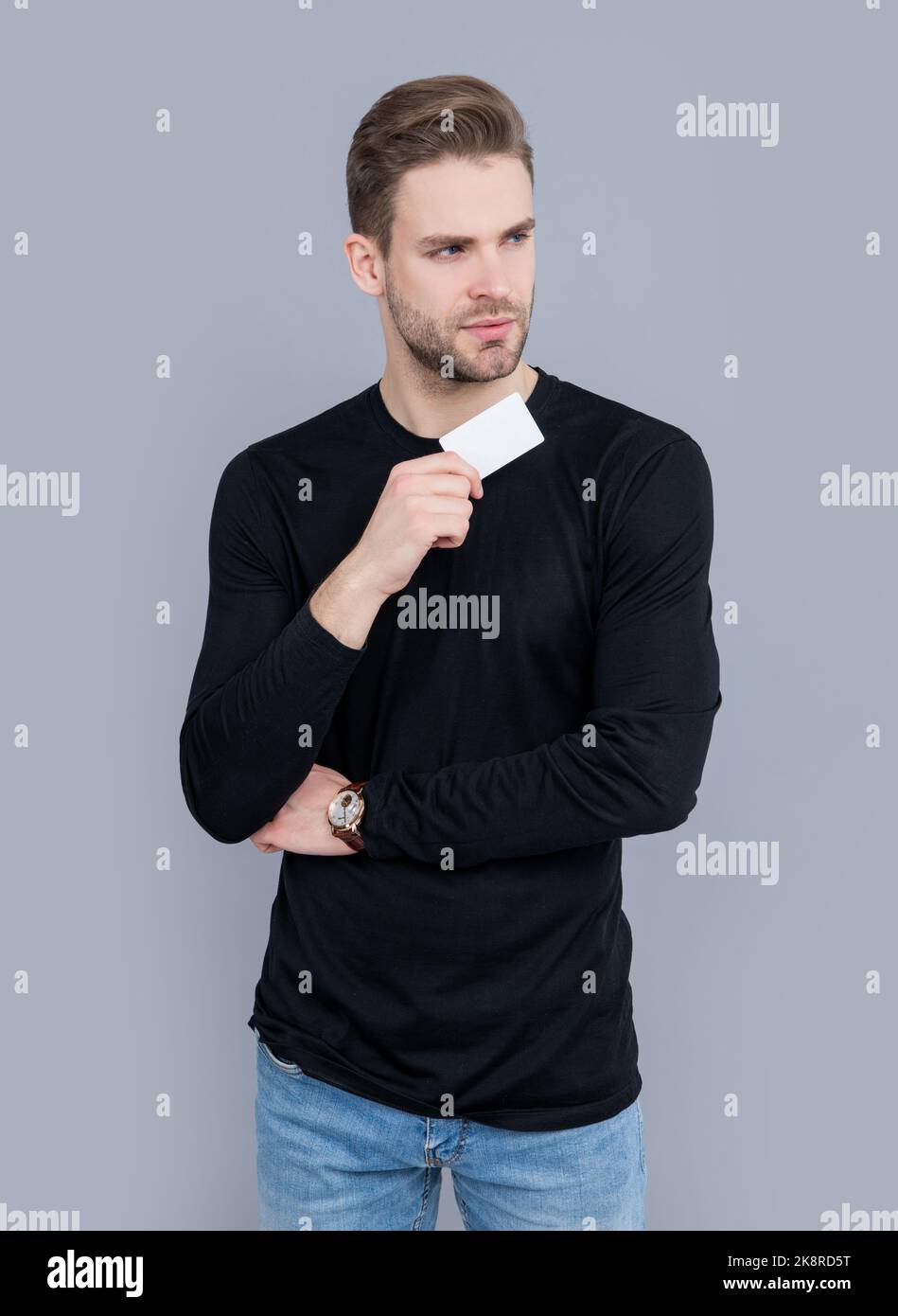 Serious man holding business card, businesscard. Guy showing debit ...