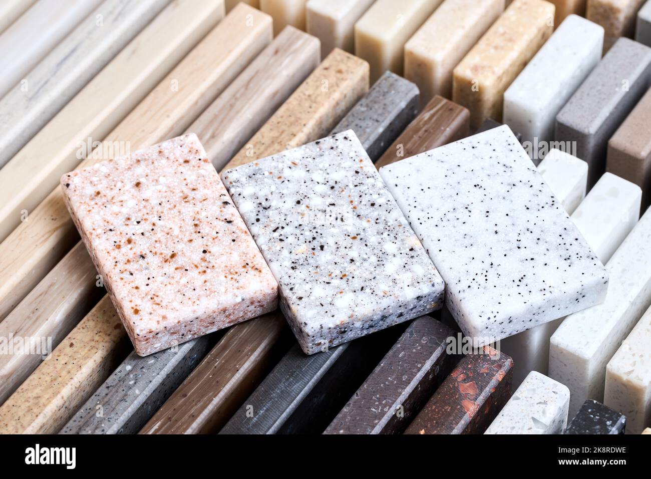 Porcelain three stoneware square samples laid on kitchen countertop ...