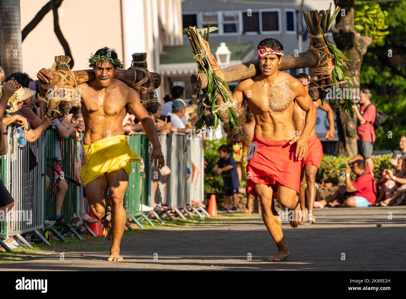People wearing traditional clothes running with fruits during a ...