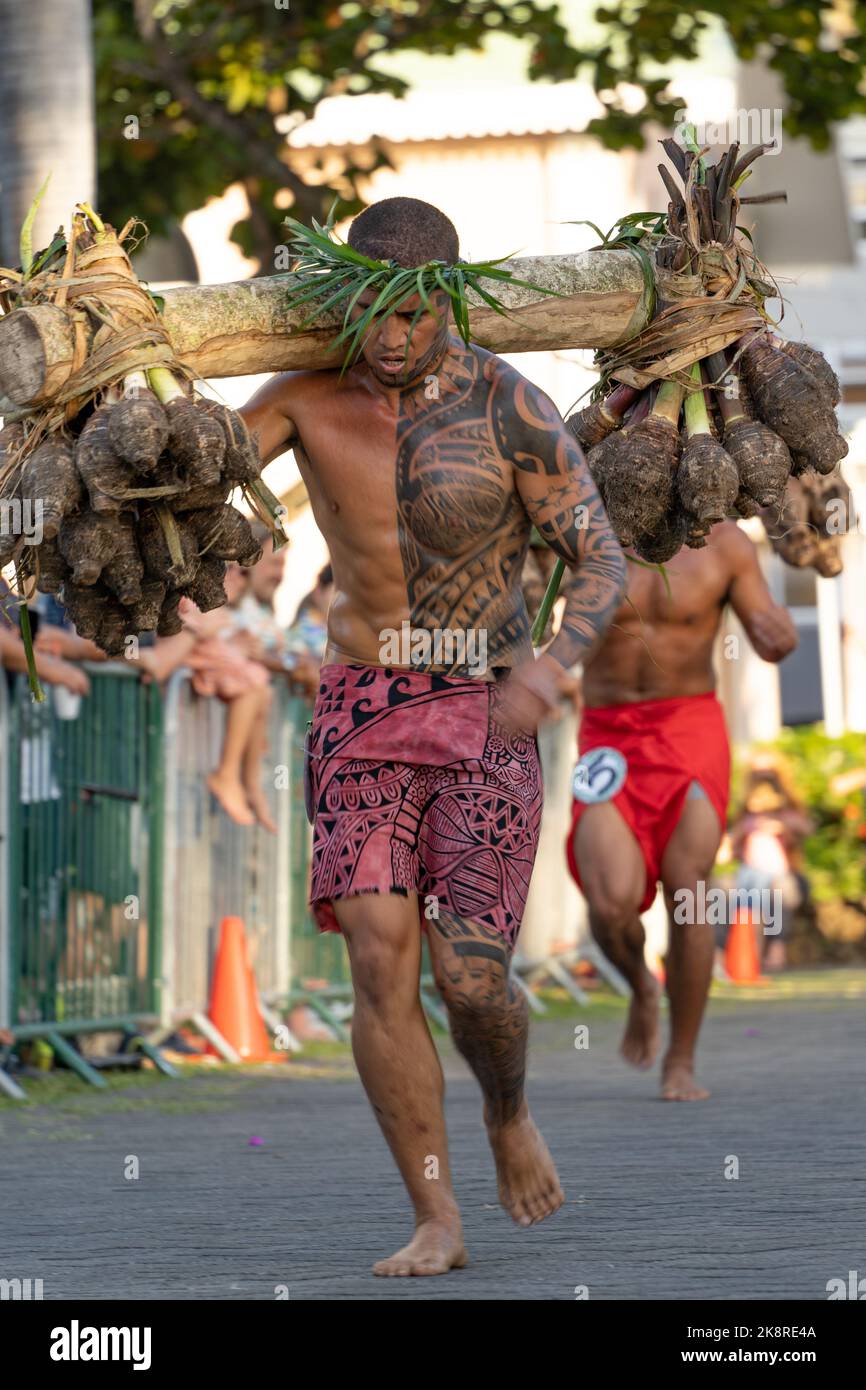 A vertical shot of people wearing traditional clothes running with ...