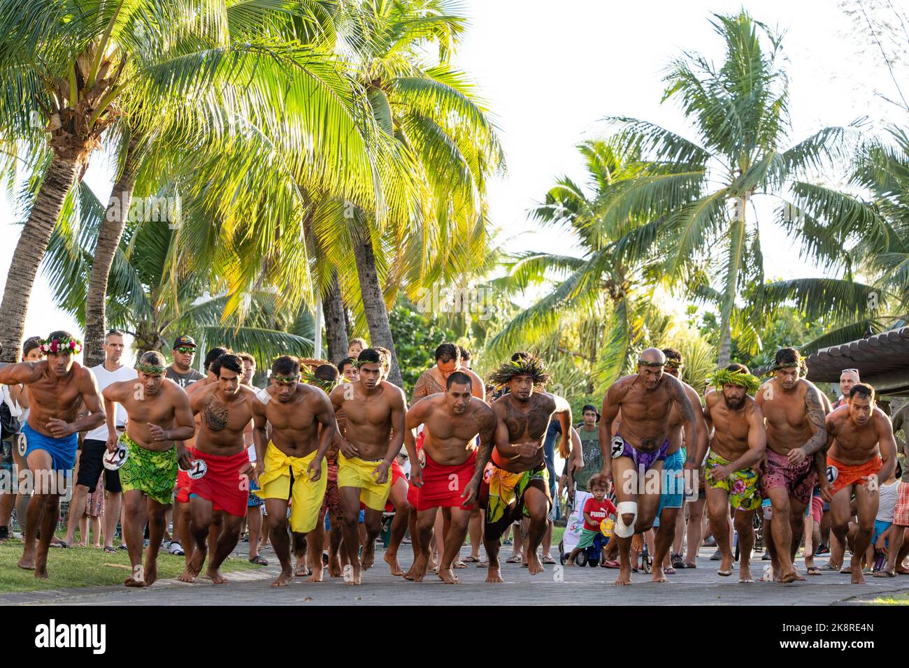 People wearing traditional clothes running with fruits during a ...