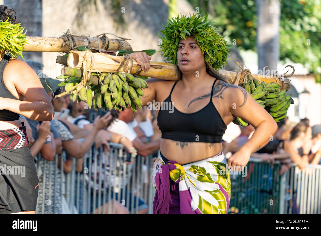 People wearing traditional clothes running with fruits during a ...